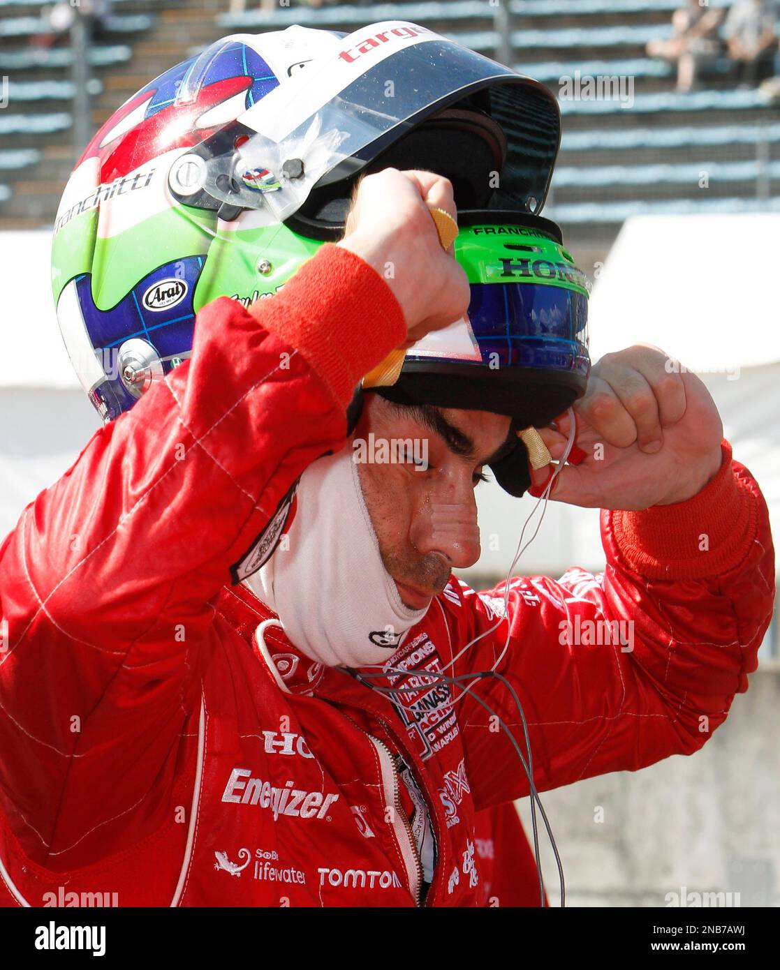 IndyCar driver Dario Franchitti of Scotland puts on his helmet for a ...