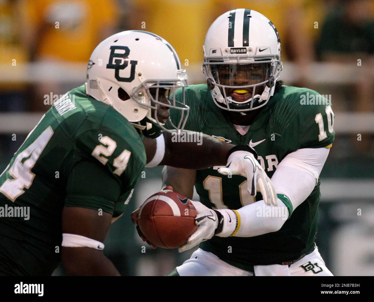 Baylor quarterback Robert Griffin III (10) hands off to running back ...