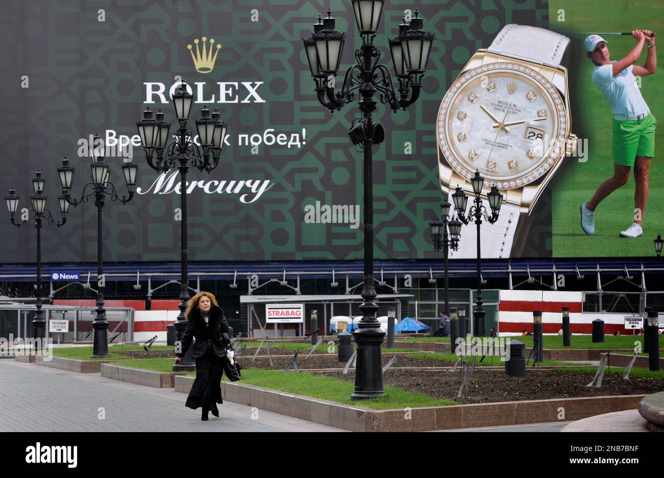 In this Oct. 20, 2008 file photo, a woman walks past a huge Rolex ...