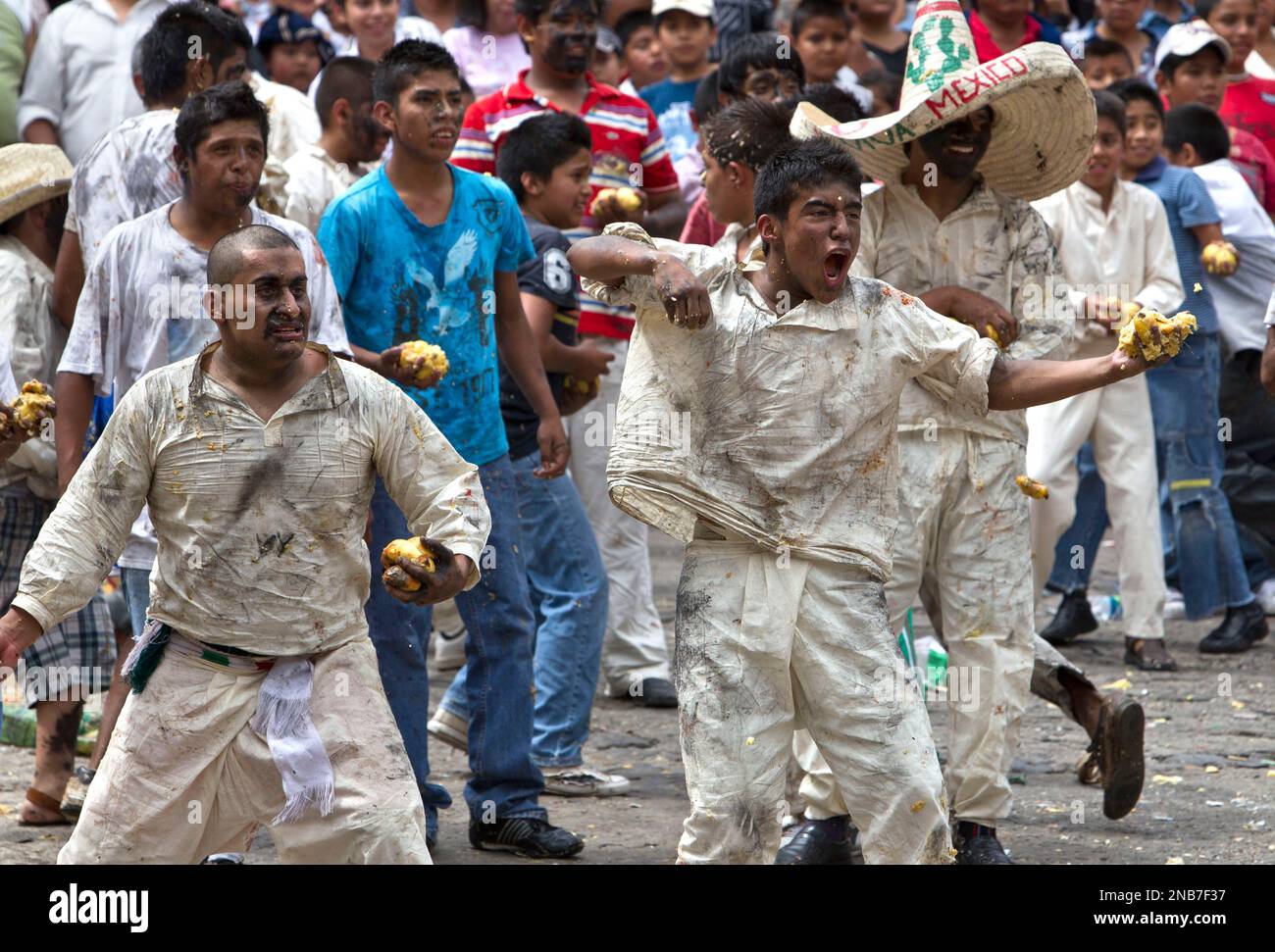 Men dressed as Mexican rebel fighters taunt their rivals, dressed as ...