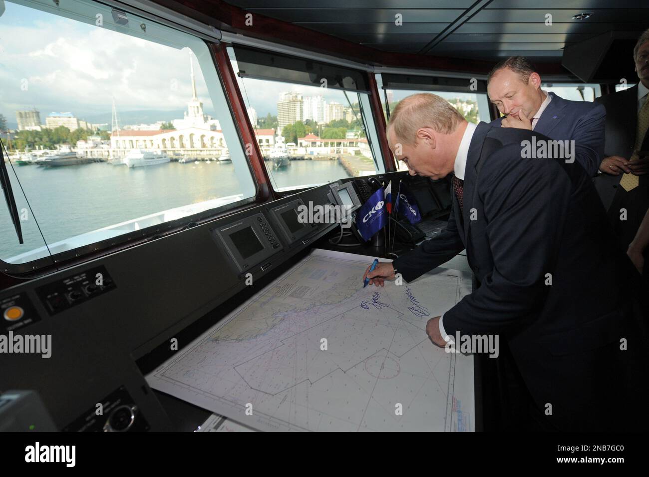 Russian Prime Minister Vladimir Putin signs his autograph on a sea map ...