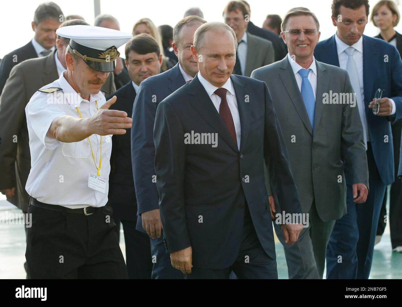 Russian Prime Minister Vladimir Putin, center, is greeted by ship ...