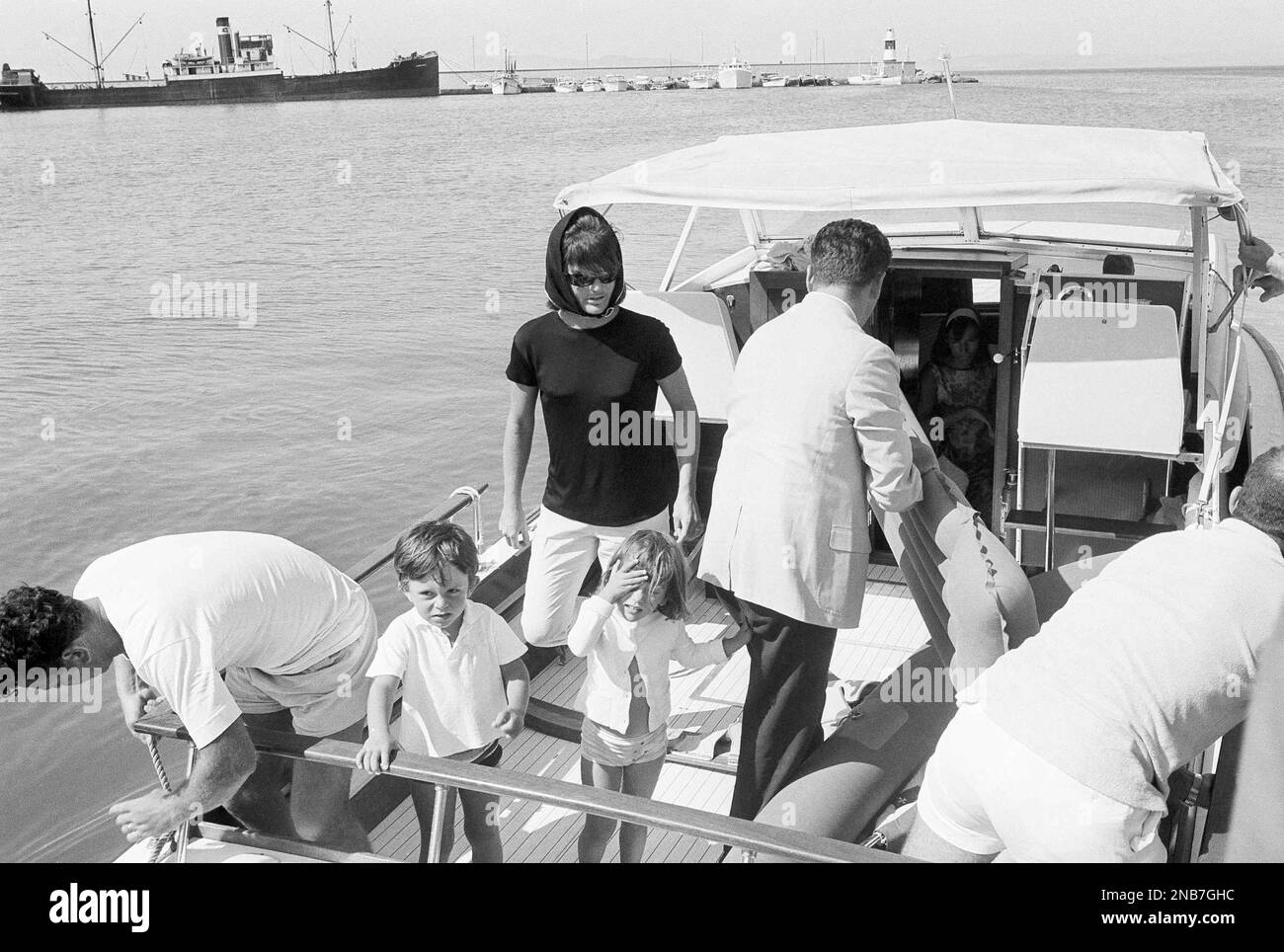 Mrs. Jacqueline Kennedy stands in a boat at Porto Ercole, Italy on ...