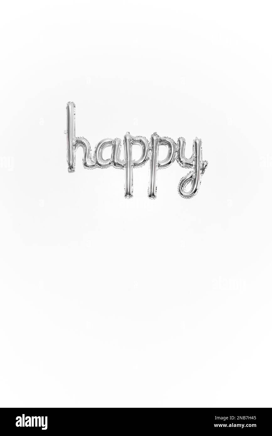 Silver happy balloon lettering center on a white wall. Foil letters ...
