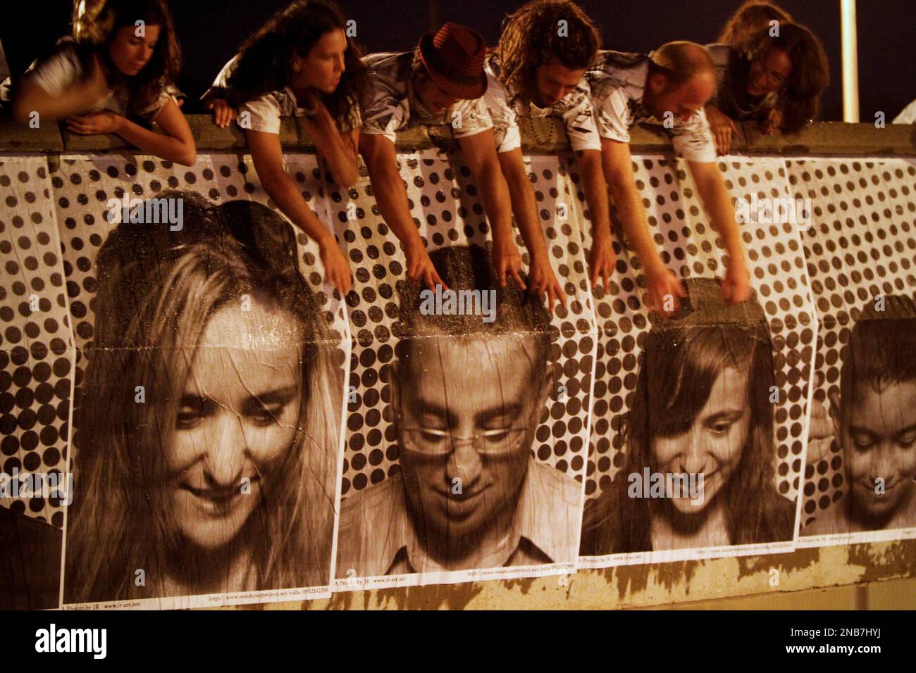 In this photo taken early Thursday, Sept. 15, Israeli artists place ...