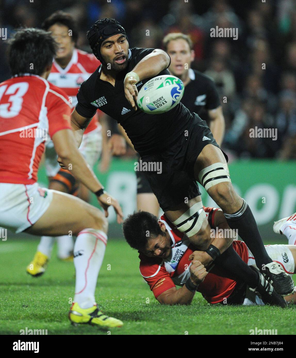 New Zealand All Blacks Victor Vito passes the ball as his tackled by ...