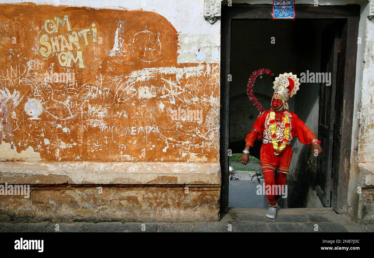A man dressed as Hindu monkey god Hanuman walks inside the ...