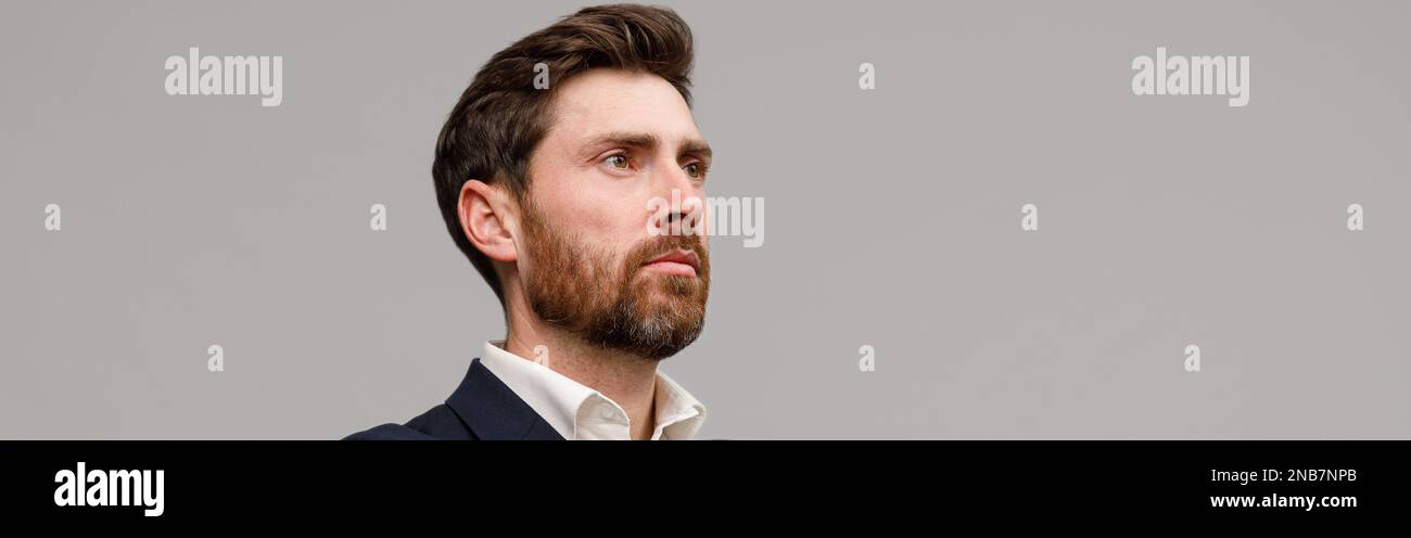 Serious business man in classic black suit with crossed hands looking ...