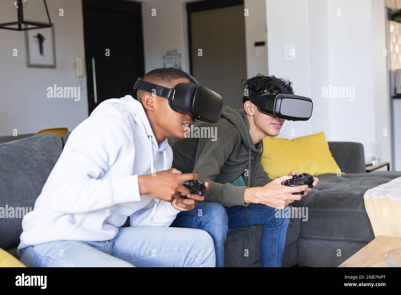 Image of diverse male teenage friends with vr glasses playing video ...