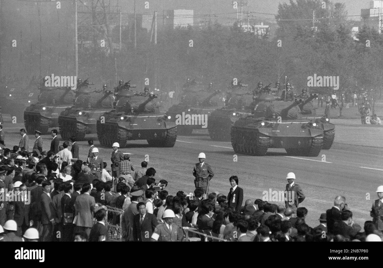 Japan’s Self Defense Forces M-61 tanks roll past spectators during a ...