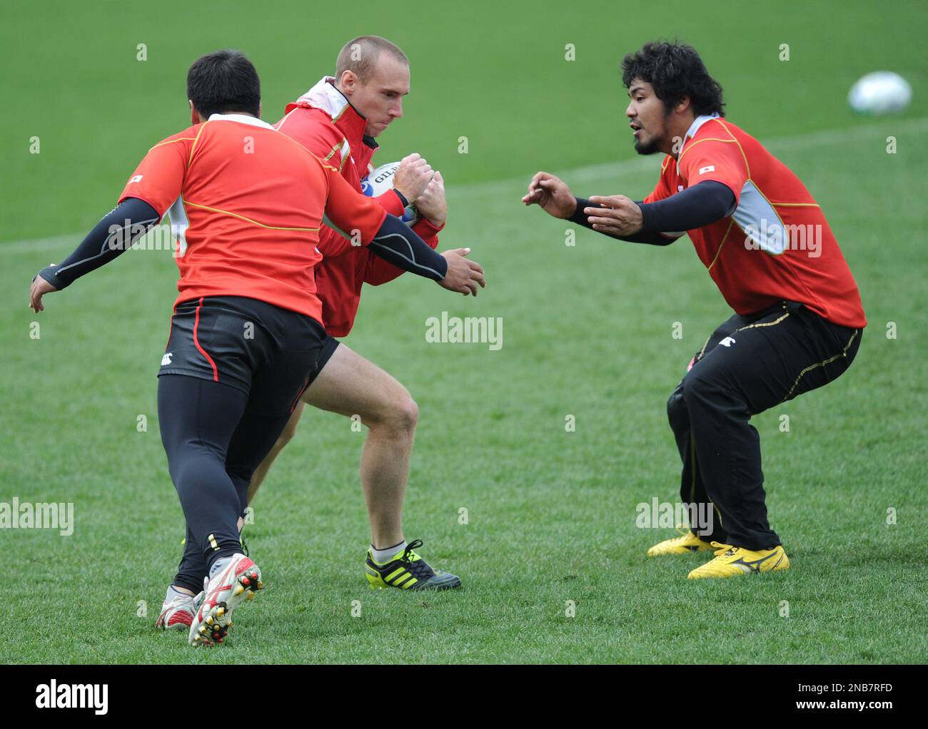 Japanese rugby player Shaun Webb, left, runs the ball at Nozomu Fujita ...