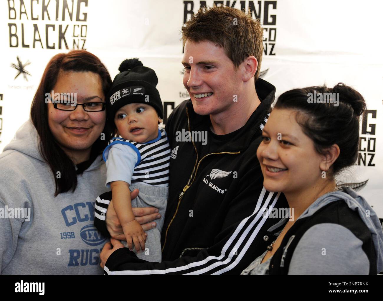 New Zealand rugby player Colin Slade poses with fans during an ...