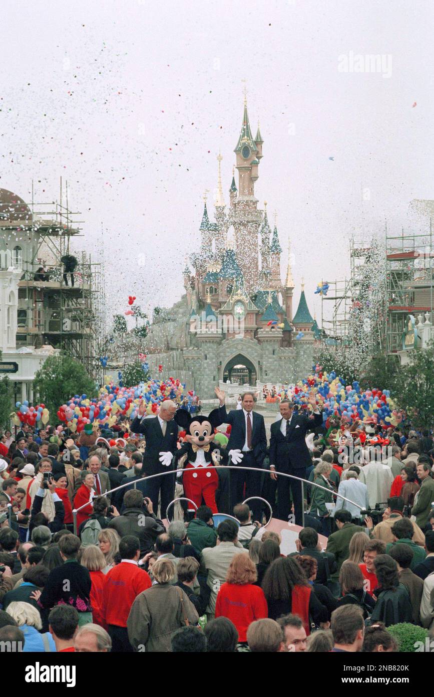 Mickey mouse and Disney CEO Michael Eisner, center, lead the ...
