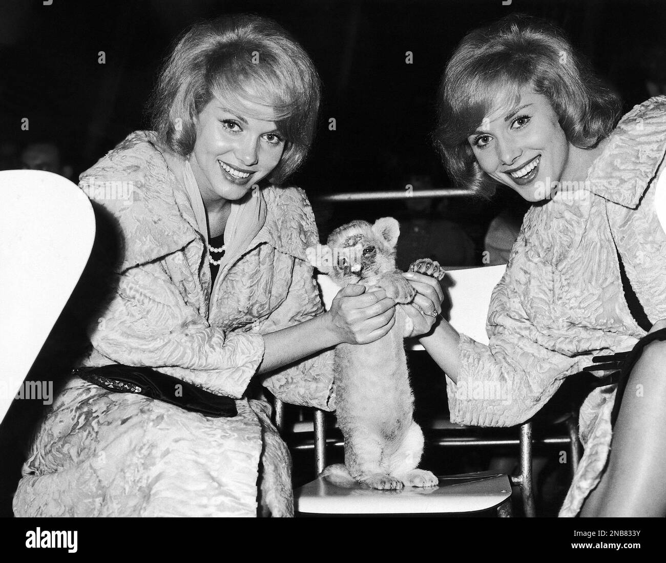 German twin dancers-actresses Alice and Ellen Kessler play with a small ...