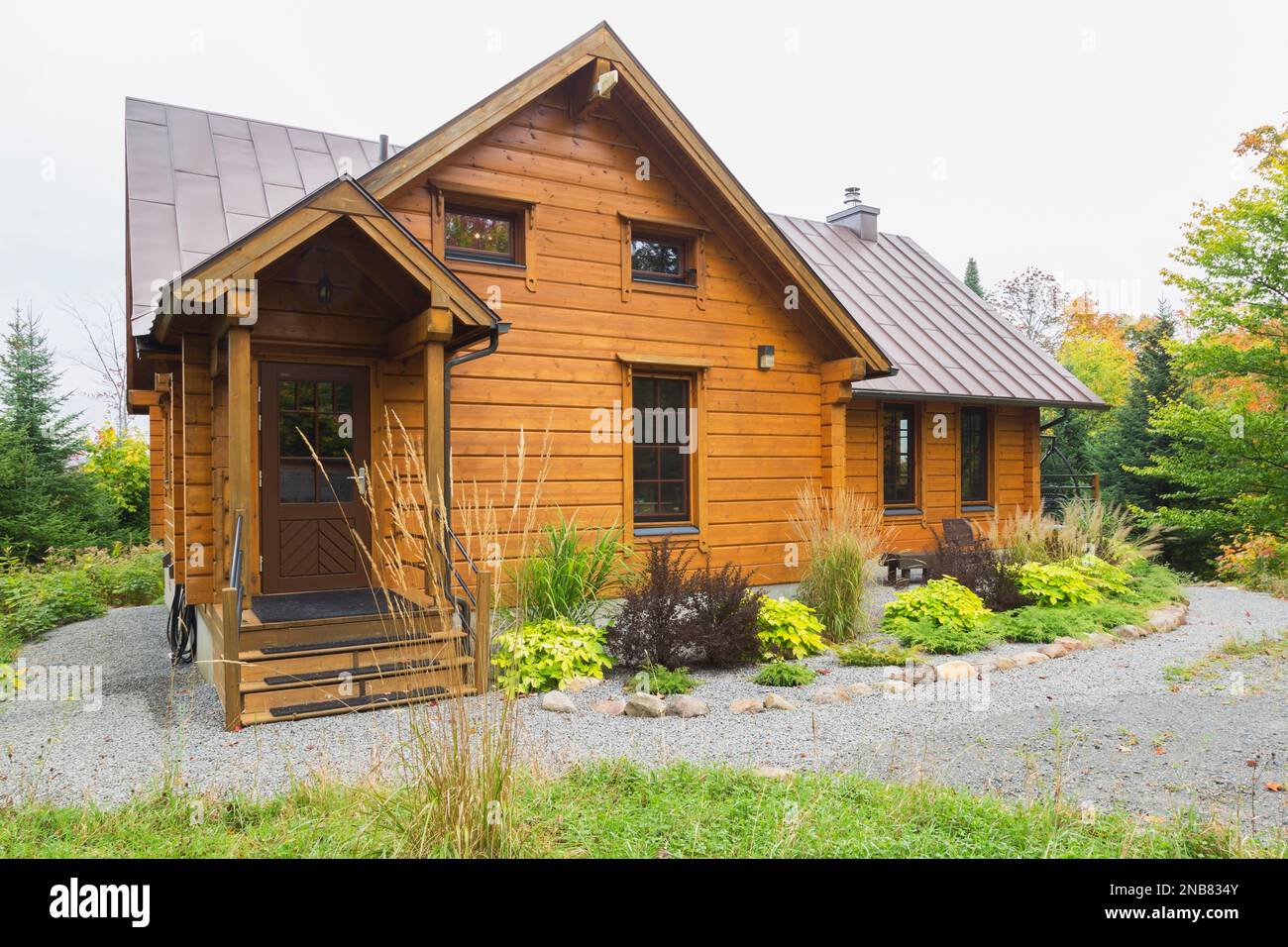 Piece sur piece Scots pine log home facade with brown standing seam ...