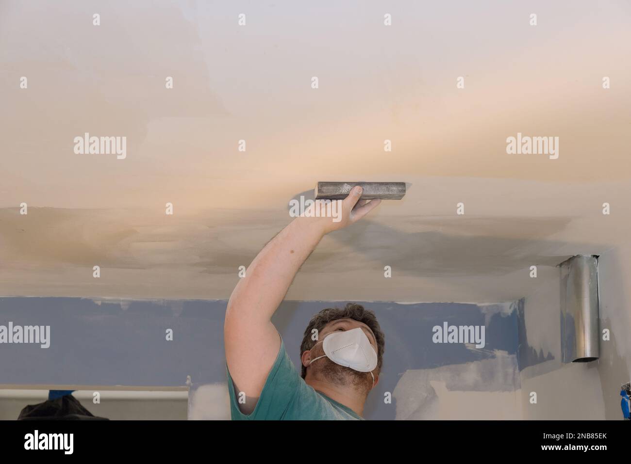 Sanding is being done by worker using sand trowel while renovating ...