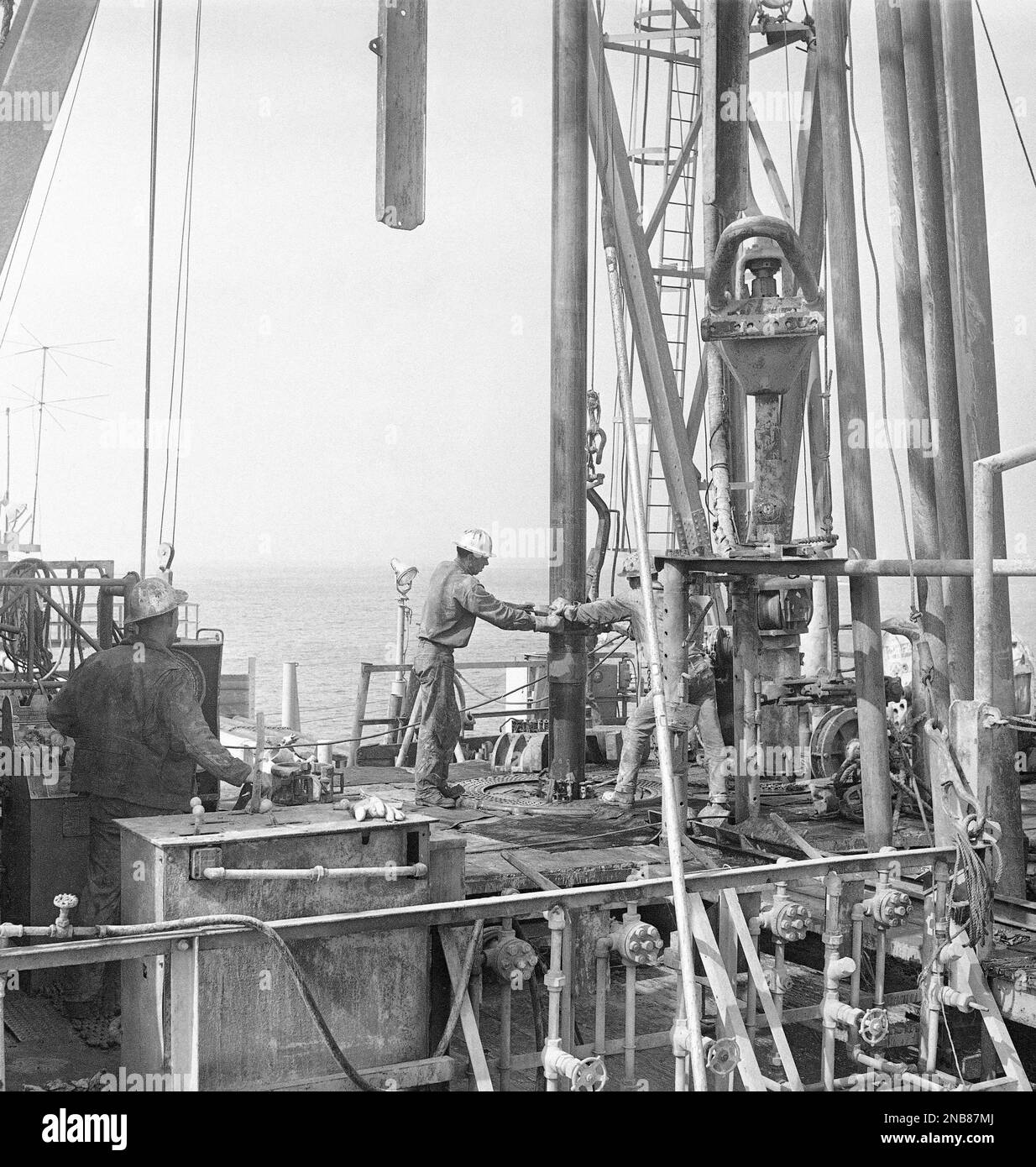 Workmen aboard the Cuss, a strange-looking ship which is pioneering new ...