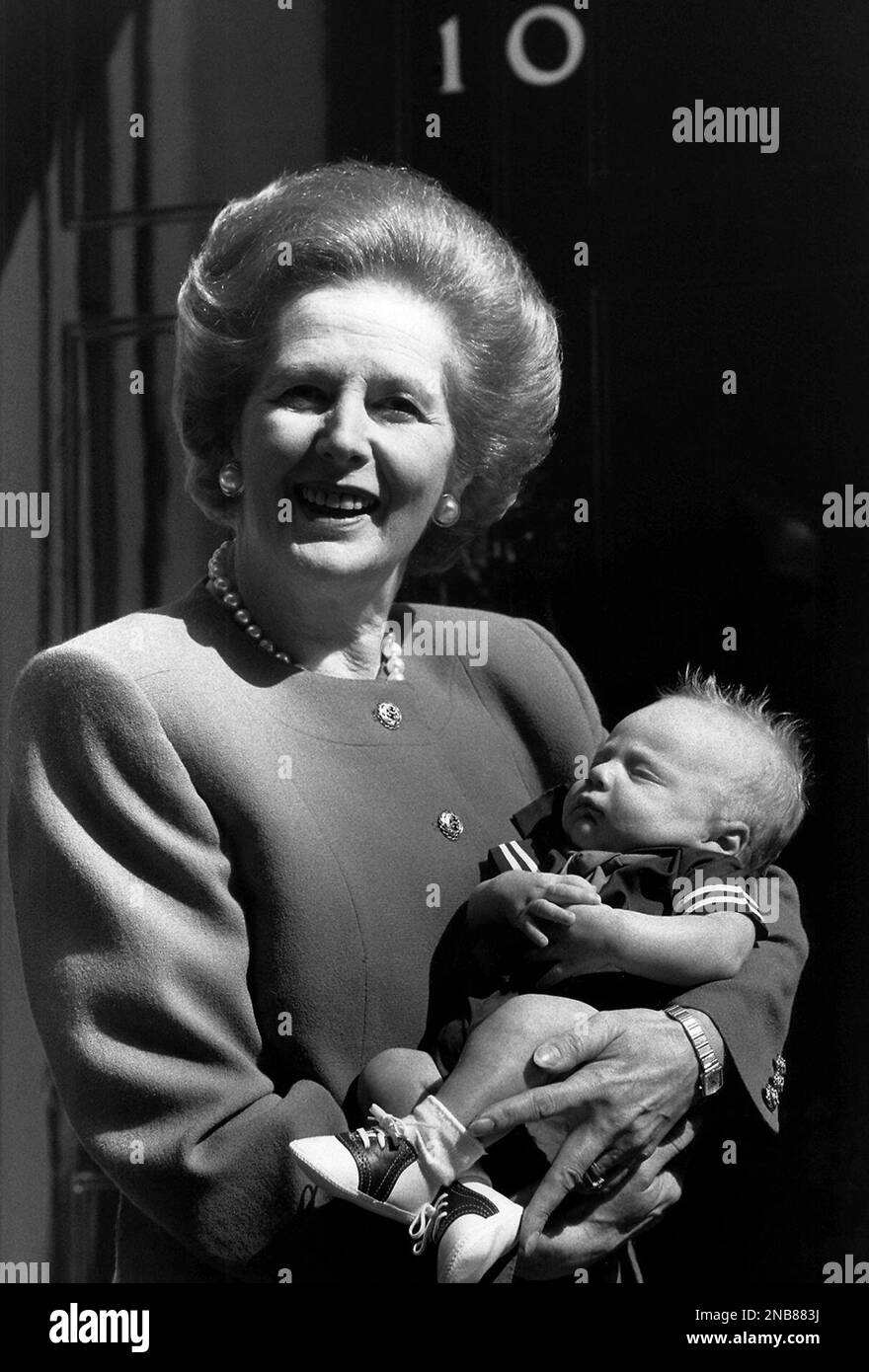 Britain's Premier Margaret Thatcher cradles her two month old grandson ...