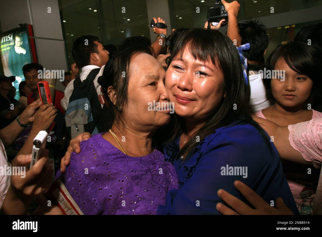 In this Sept. 11, 2011 photo, Myanmar female artiste Chaw Su Myo, right, cries as she hugs her ...