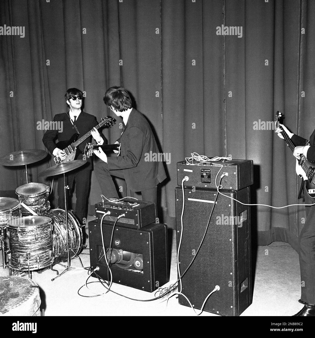 Members of the Beatles John Lennon and George Harrison, turned away ...