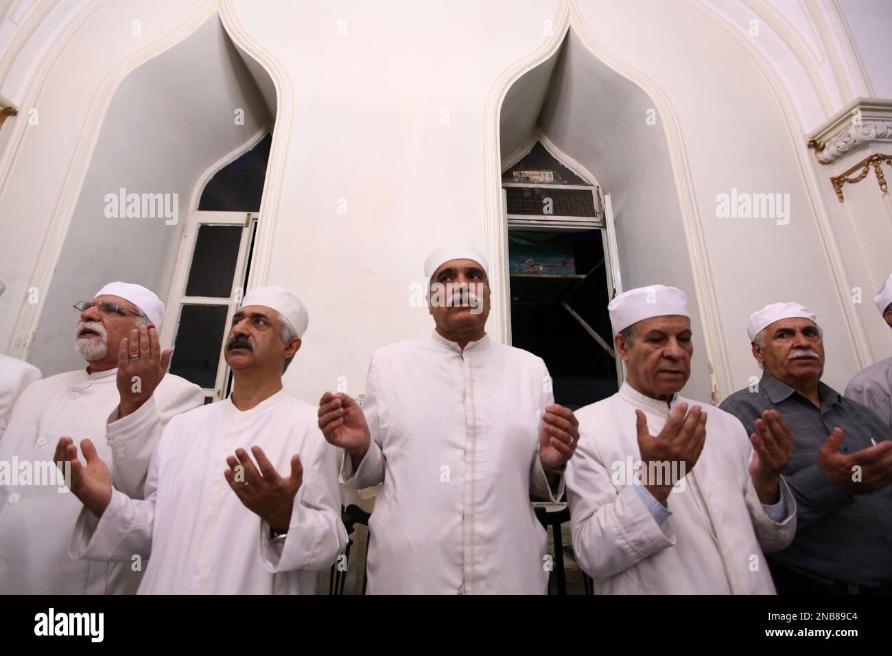 Iranian Zoroastrian priests perform a ritual at a fire temple in Tehran ...