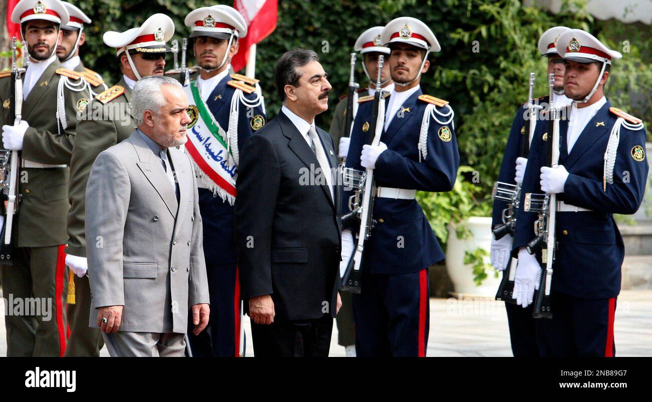 Pakistani Prime Minister Yousuf Raza Gilani, center, is accompanied by ...