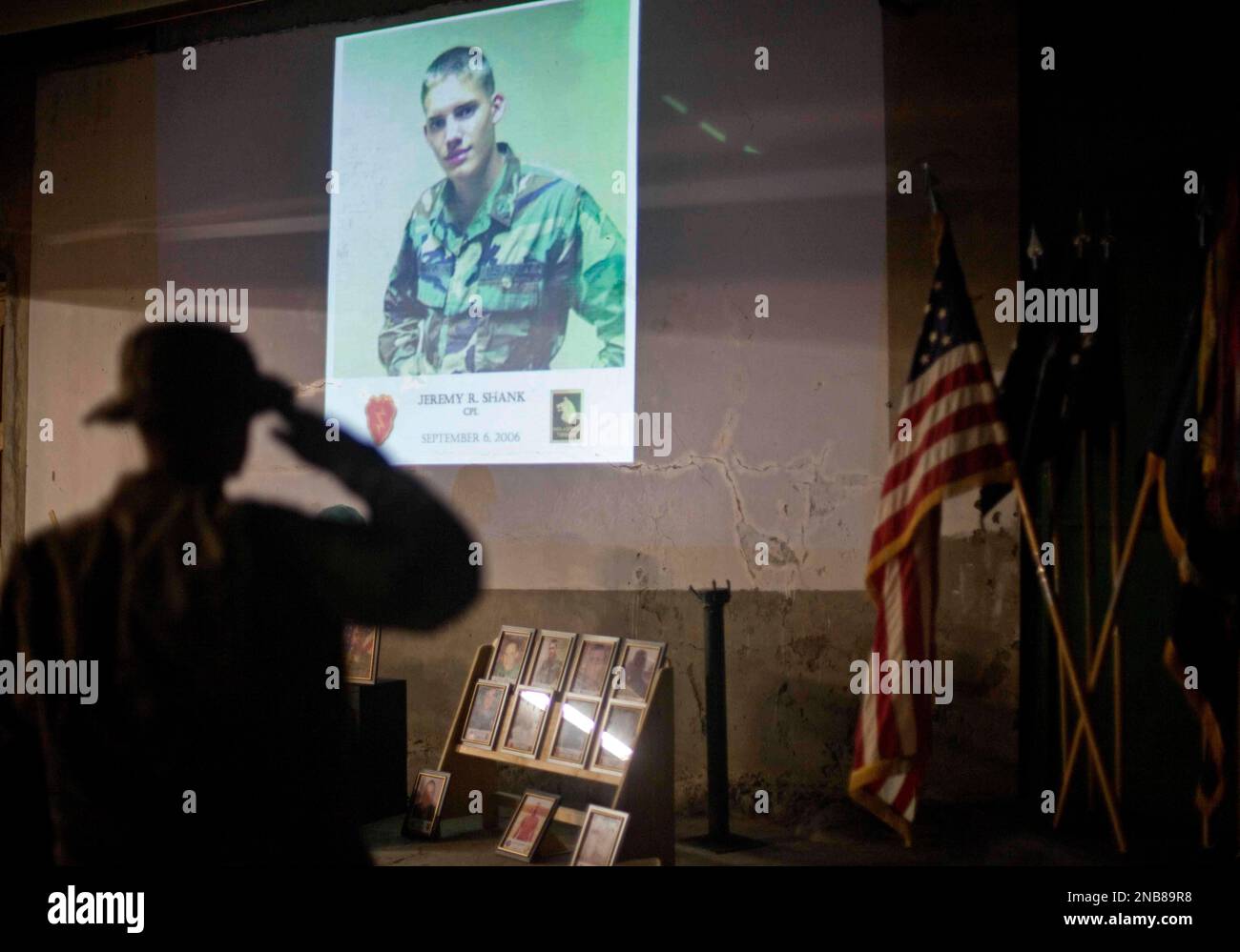 An image of Cpl. Jeremy Shank is projected above as Pfc. Mark Hasse, 25 ...