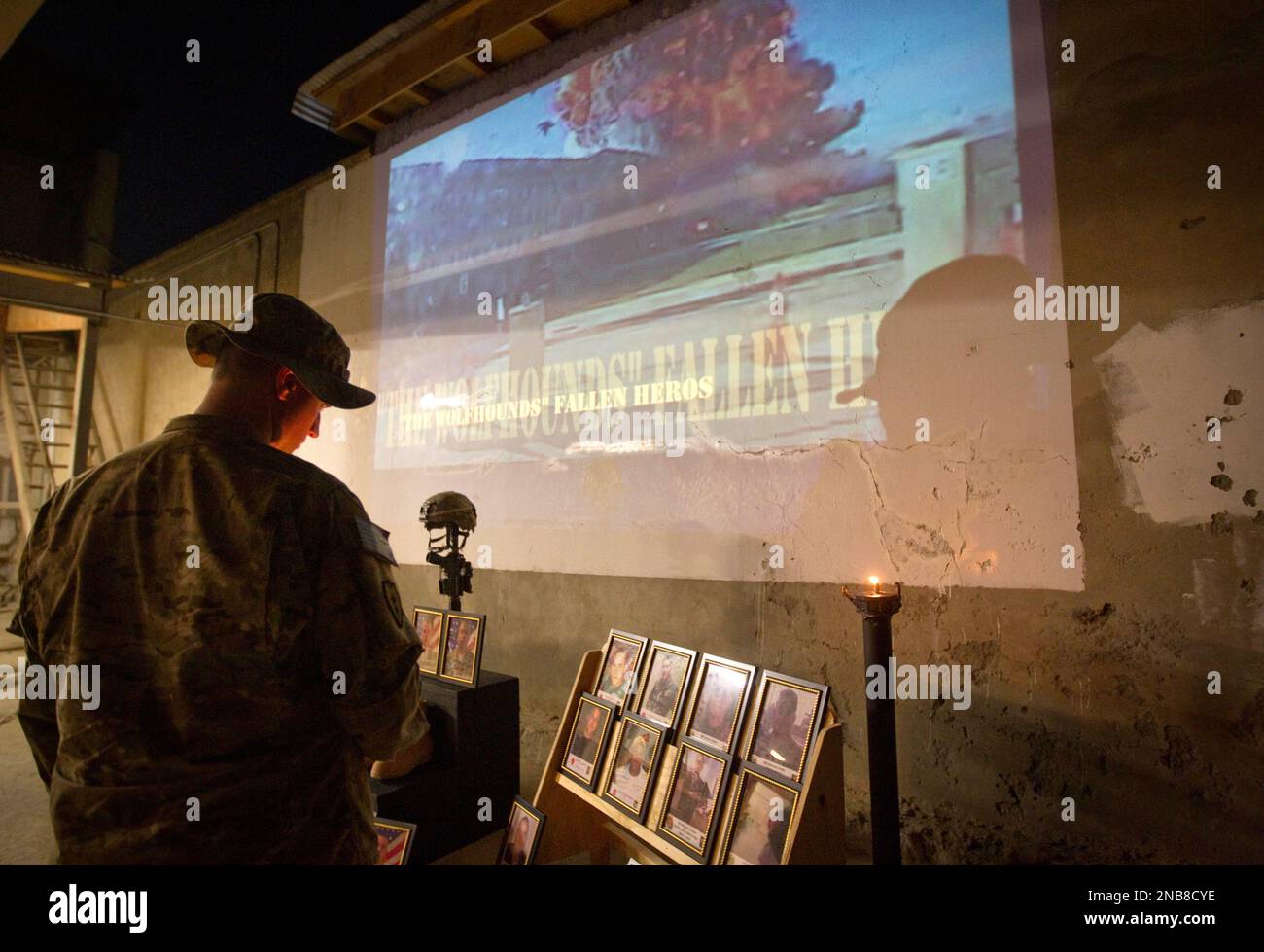 An image of the 9/11 attack on the Pentagon is projected above as Pfc ...