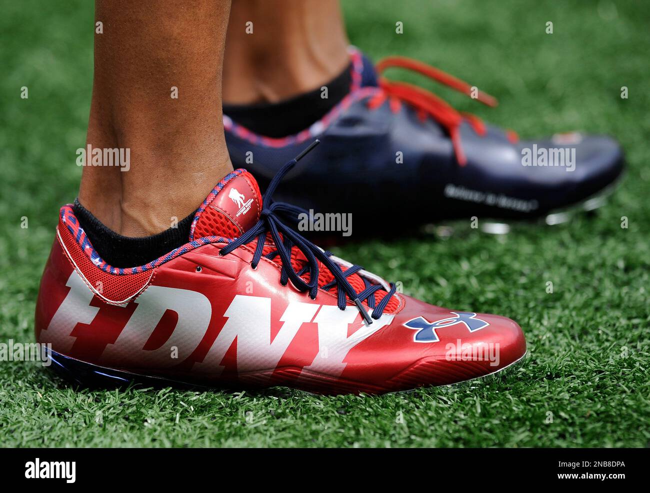 A member of the Baltimore Ravens wears cleats emblazoned with "FDNY" in ...