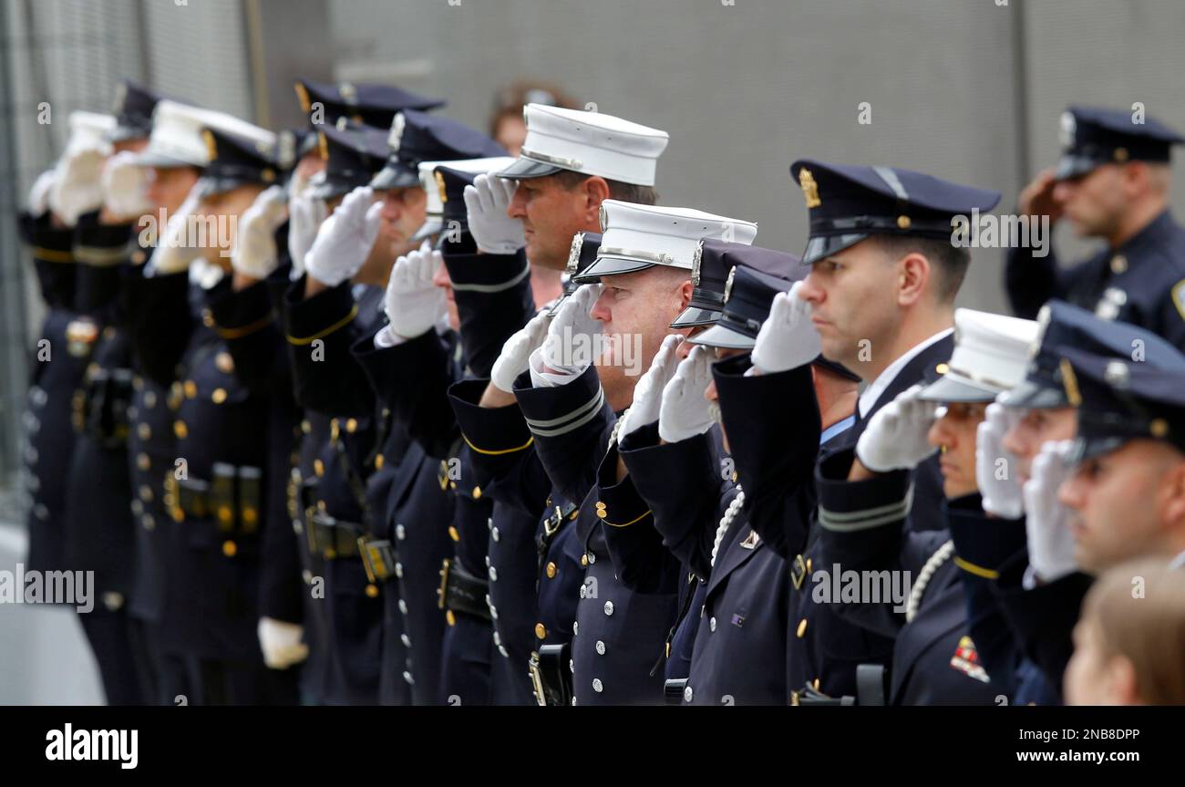 Firefighters salute as taps is played after a ceremony marking the 10th ...