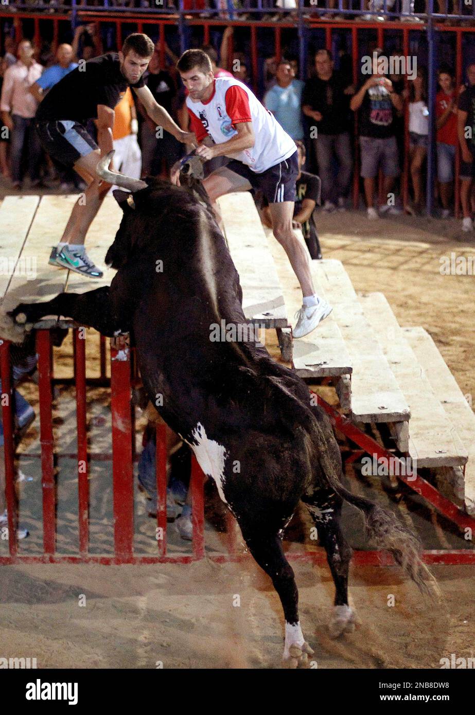 In this Sept. 9, 2011 photo, a reveler runs away from 'Raton' the ...