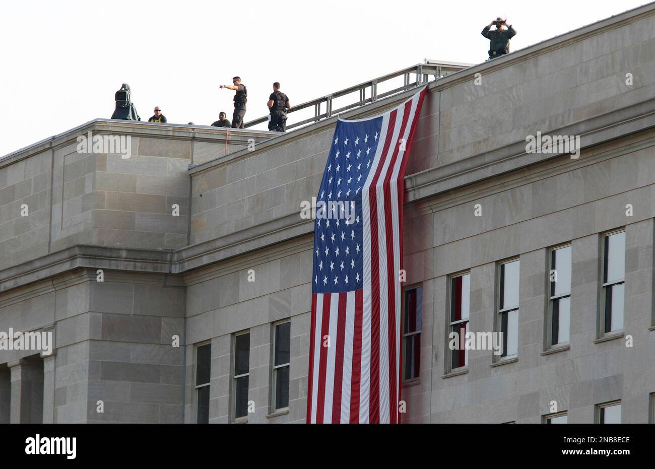 A Secret Service counter-sniper team looks out from atop the Pentagon ...