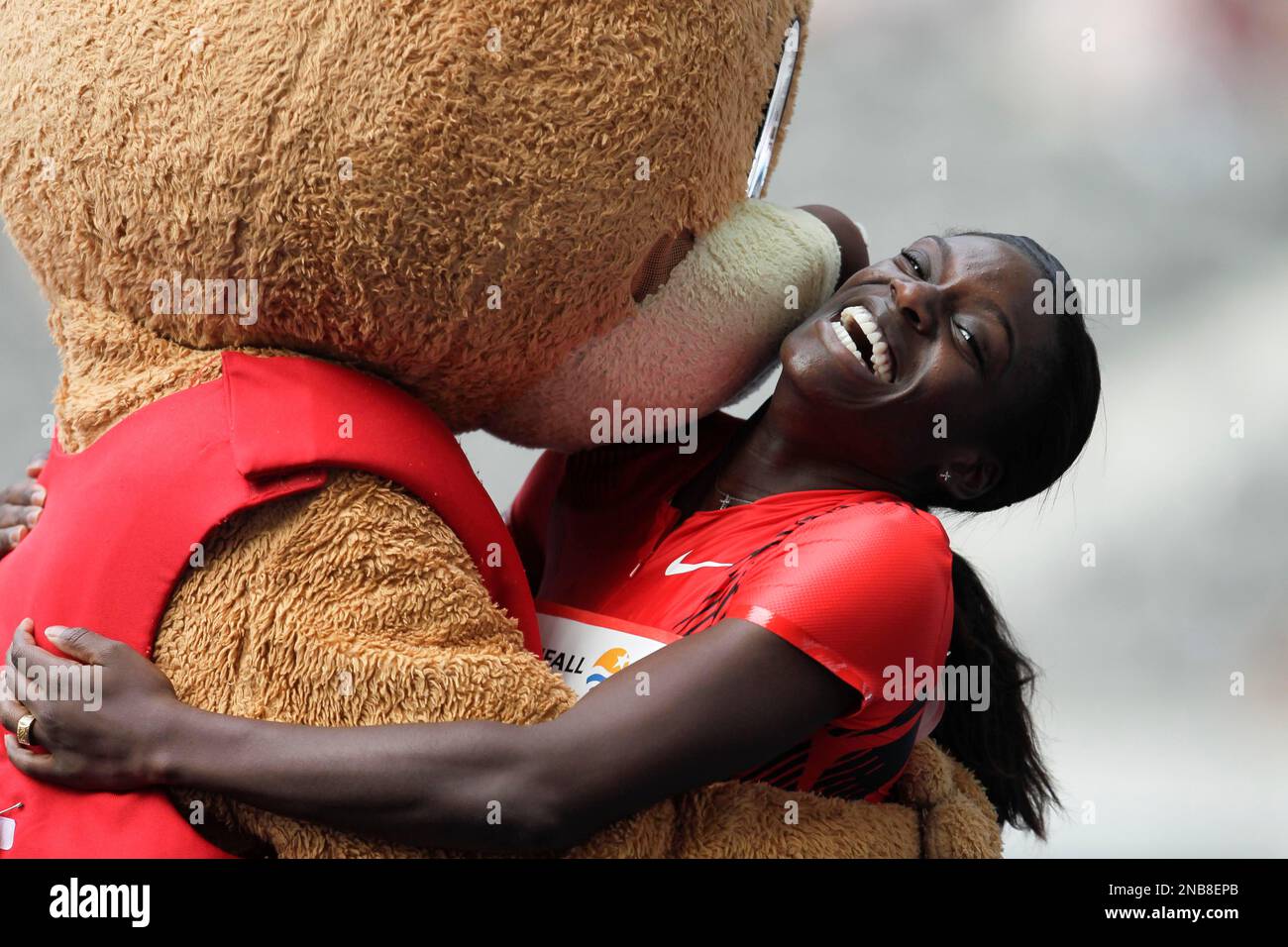 Dawn Harper, right, of the U.S. embraces a Berlin bear mascot after she ...
