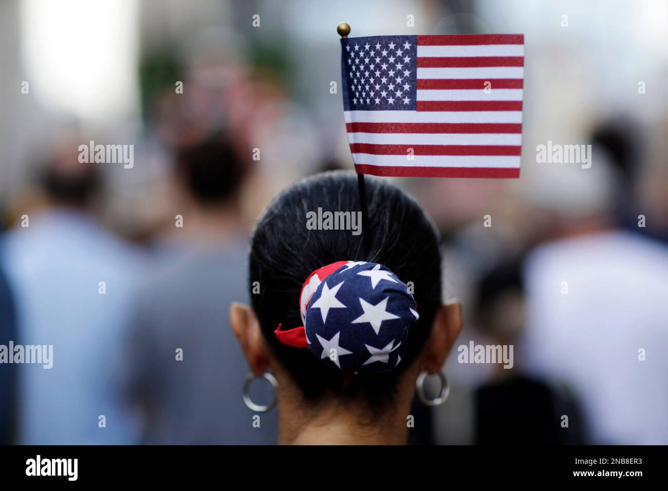 People stand in the street in lower Manhattan Sunday, Sept. 11, 2011 ...