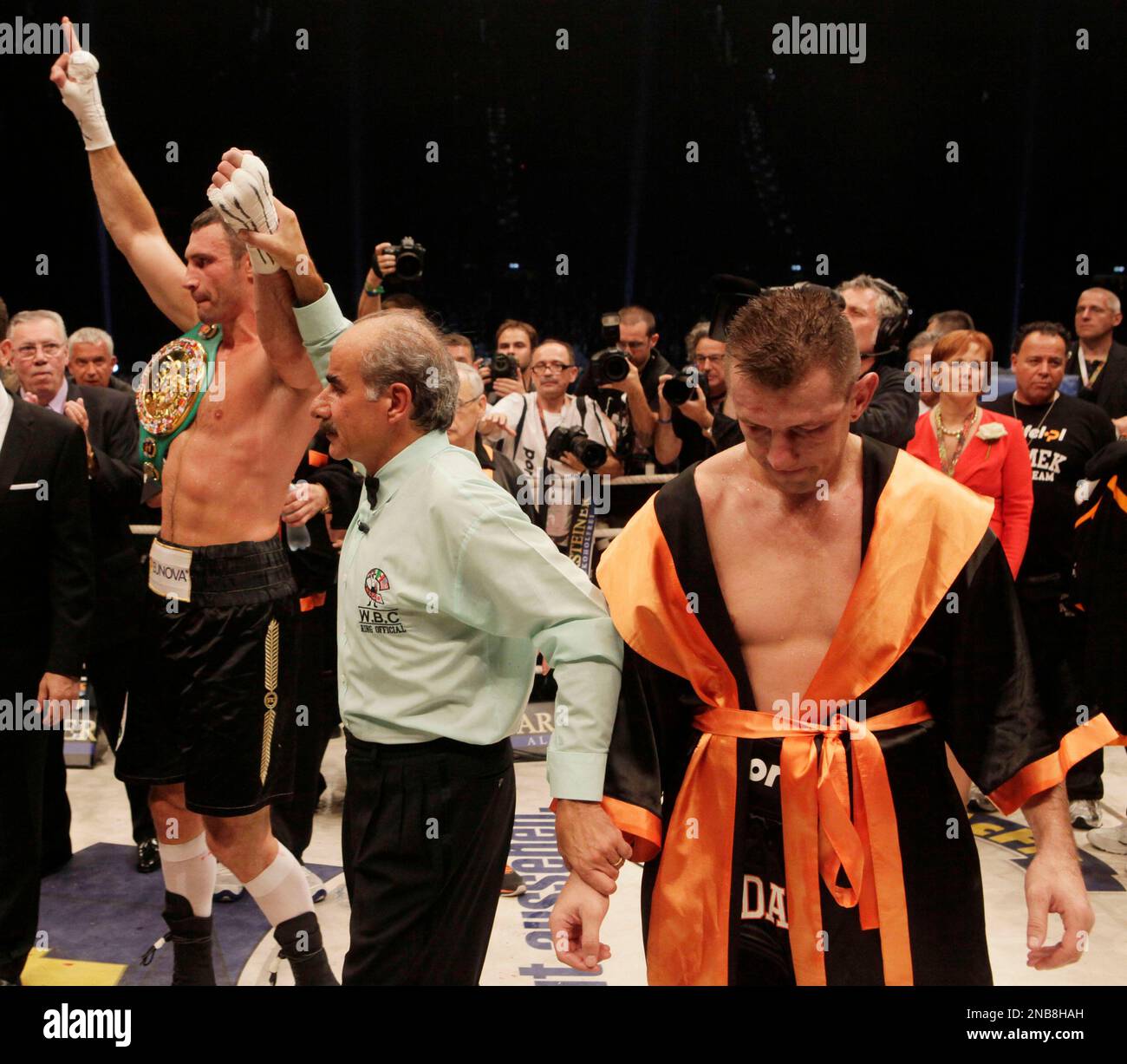 Referee Massimo Barrovecchio of Italy, center, raises the hand of the winner, Vitali Klitschko ...