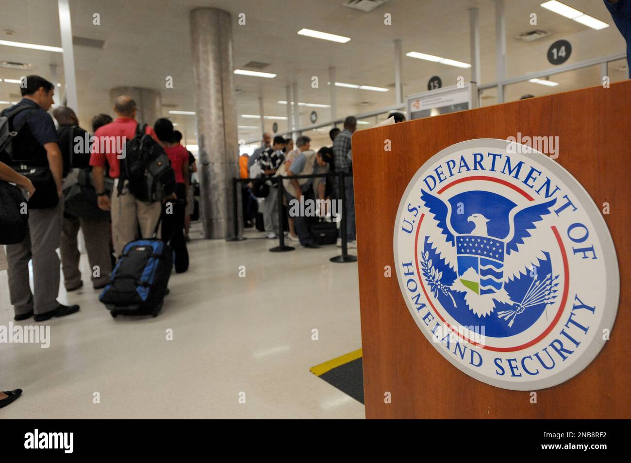 Airline passengers wait go through the Transportation Security ...