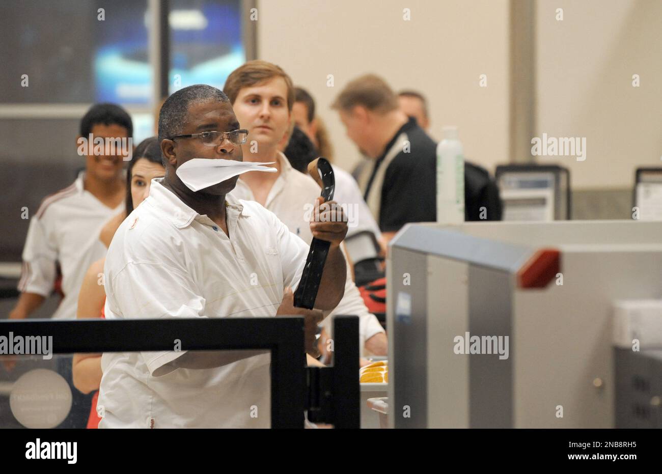 Airline passengers go through the Transportation Security ...