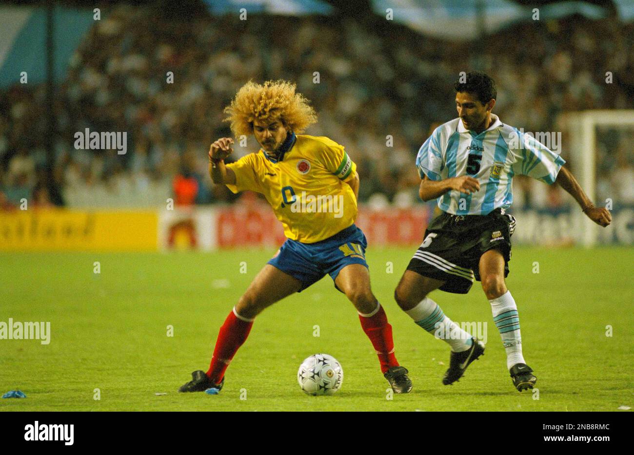 Colombia's Carlos Valderrama, left, fights for the ball with Argentina ...
