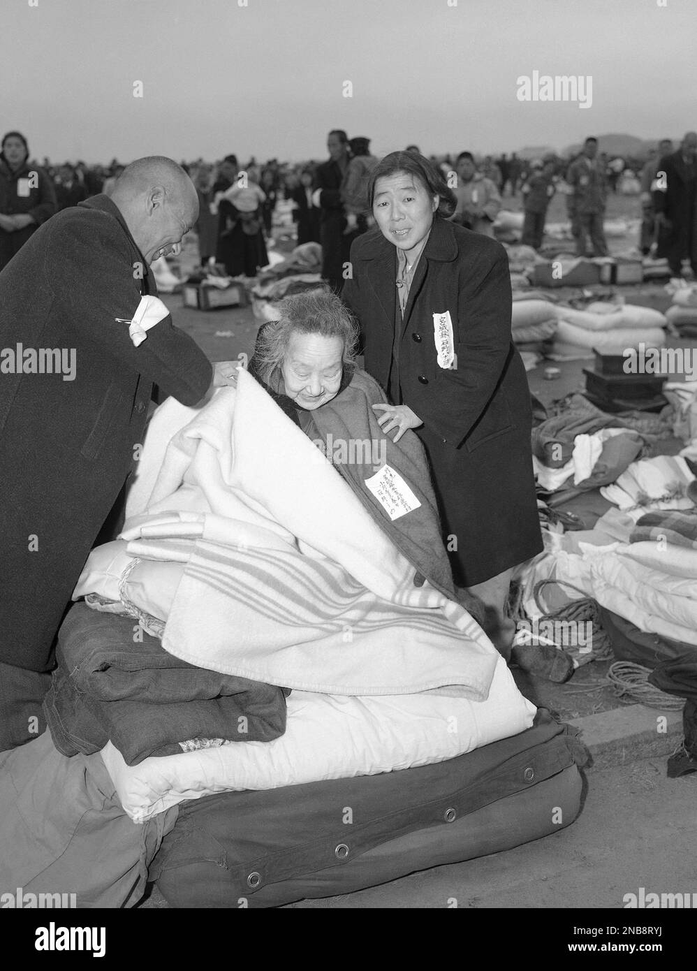 An old lady gets help from her children in Shanghai on Feb. 1, 1946 ...