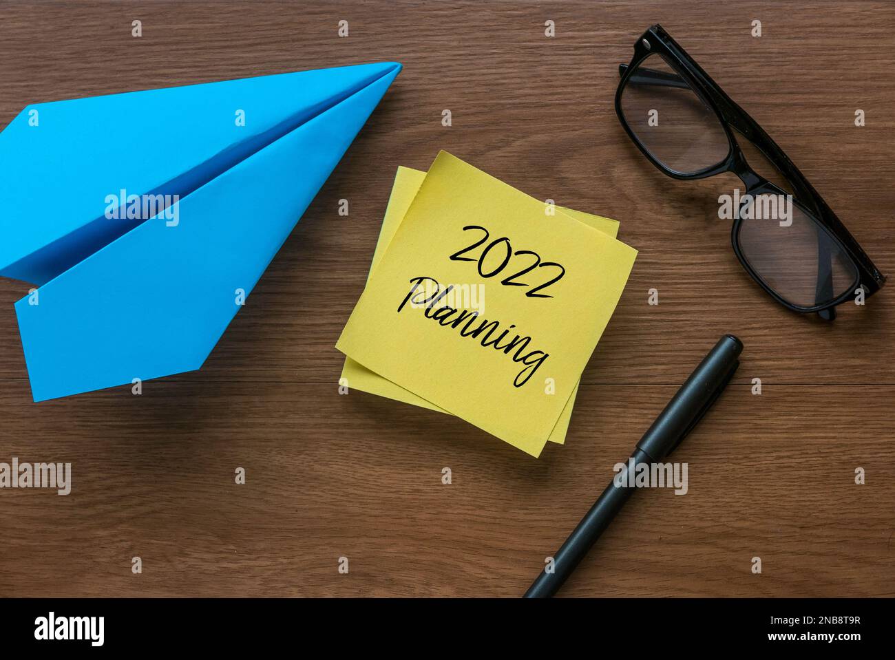 2022 planning written on yellow memo note with paper plane, pen and ...