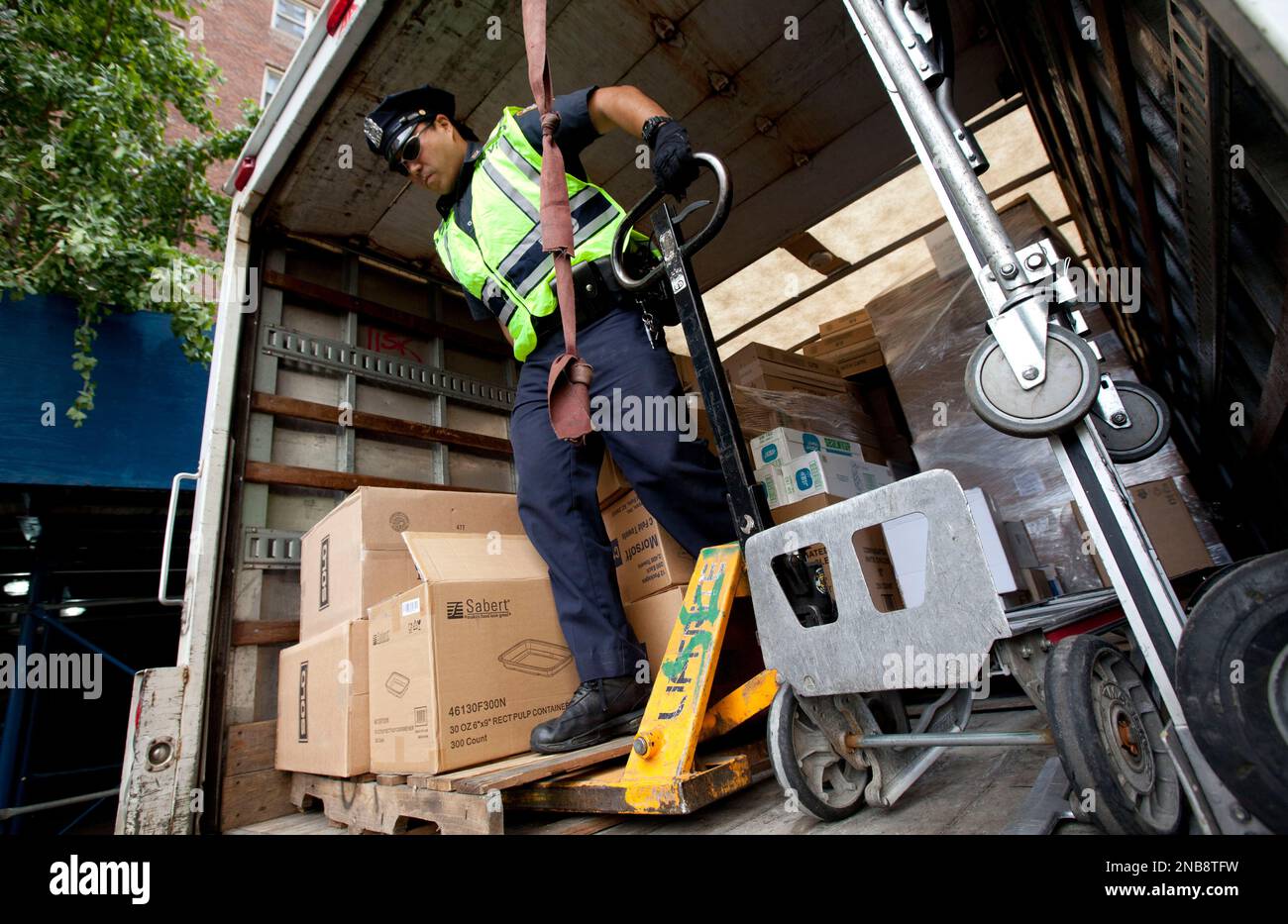 A New York City Police officer examines a delivery truck at a vehicle ...