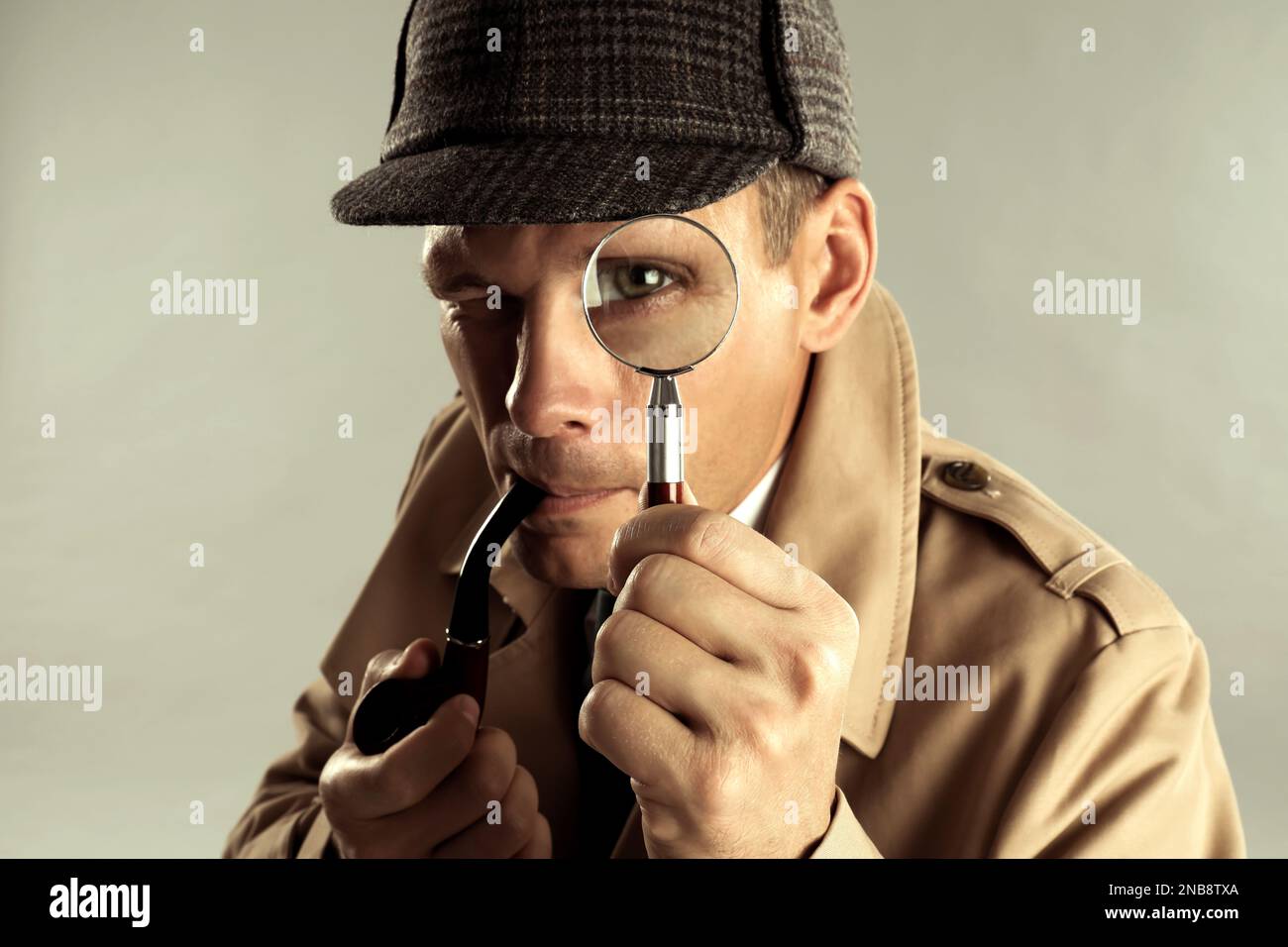 Male detective with smoking pipe looking through magnifying glass on ...