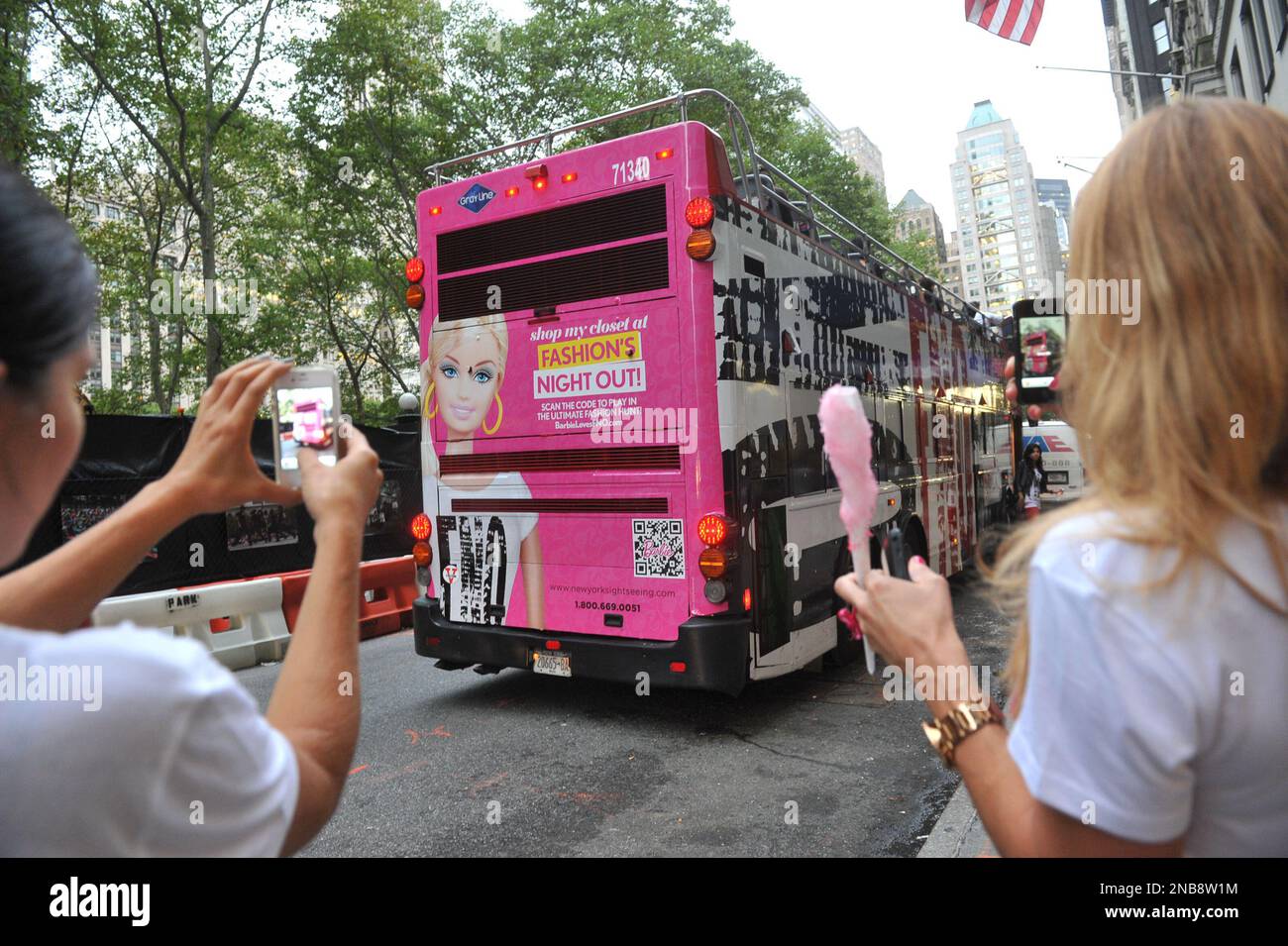 People scan the QR code on the back of the official Barbie FNO double ...