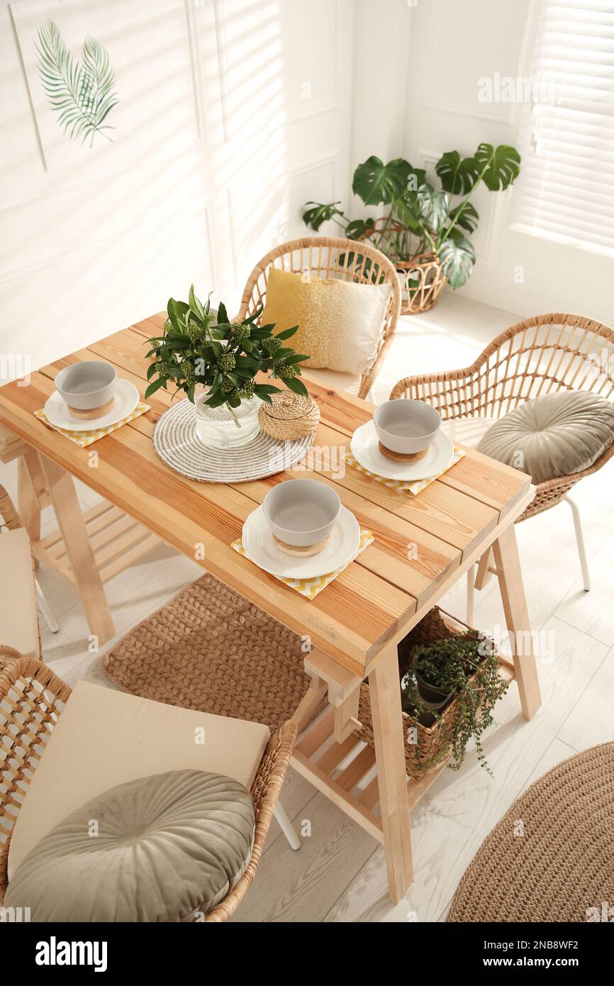 Stylish wooden dining table and chairs in room. Interior design Stock ...