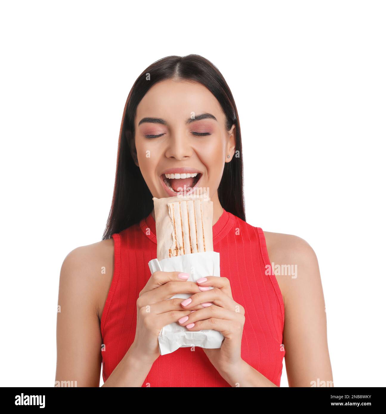 Young woman eating delicious shawarma on white background Stock Photo ...