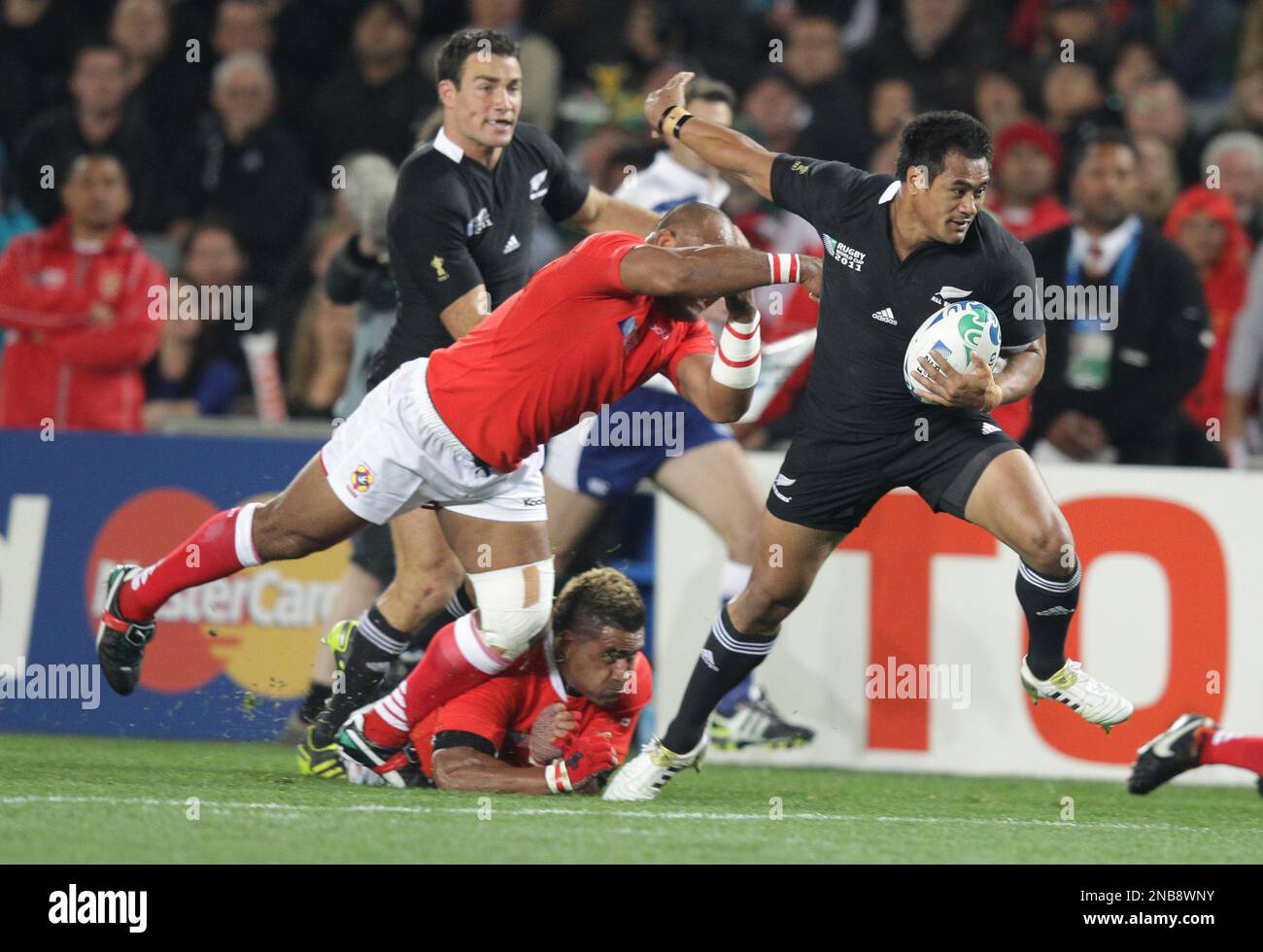 New Zealand All Blacks' Isaia Toeava breaks the tackle of Tonga's Aleki ...