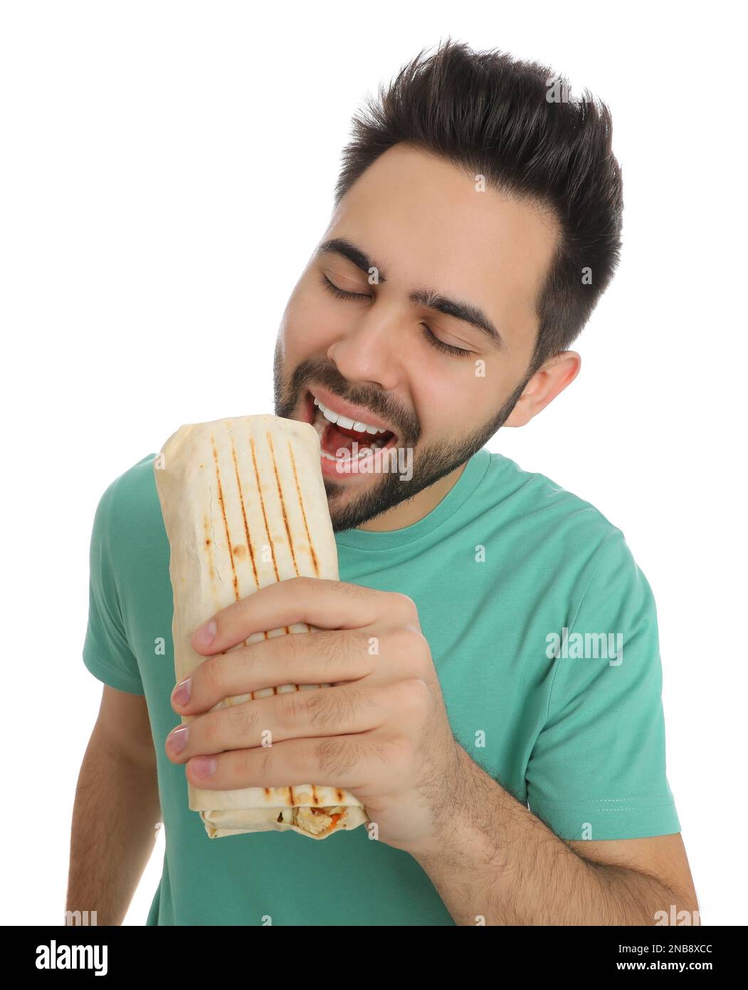 Young man eating tasty shawarma isolated on white Stock Photo - Alamy