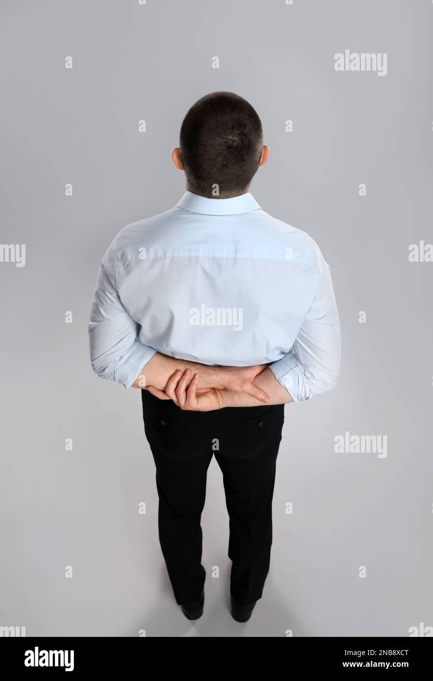Man in formal clothes on grey background, back view Stock Photo - Alamy