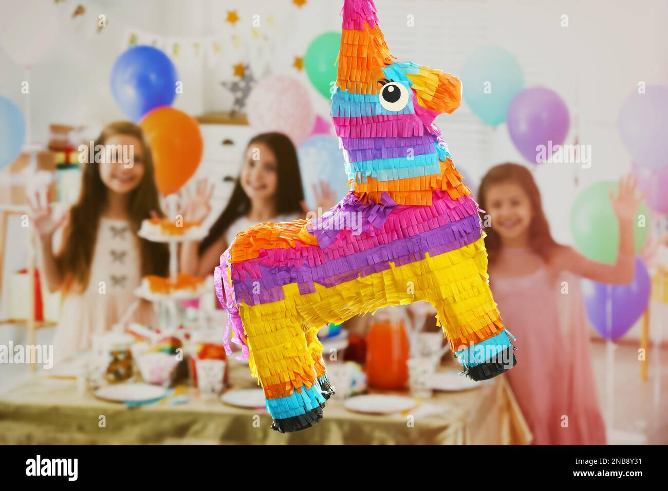Bright festive pinata hanging indoors at birthday party Stock Photo - Alamy