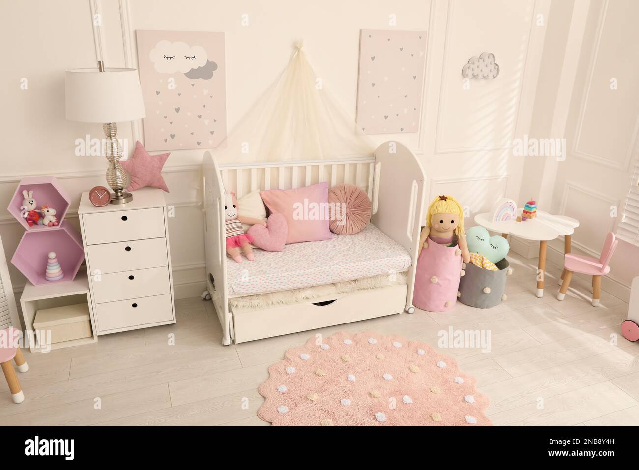 Cozy baby room interior with crib and toys Stock Photo - Alamy